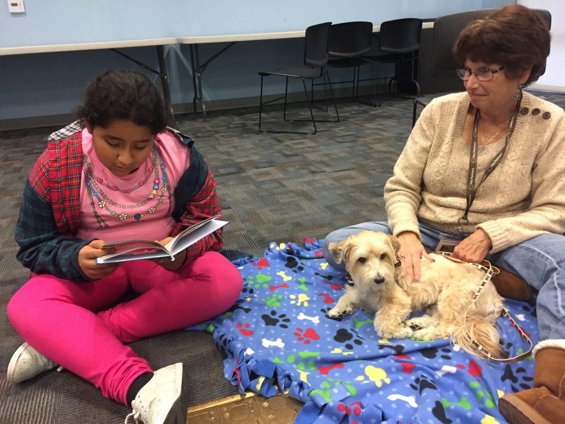 Children spend afternoon reading to therapy dogs at the library